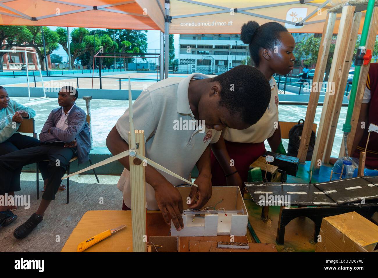 A group of students works on a windmill prototype to demonstrate wind ...
