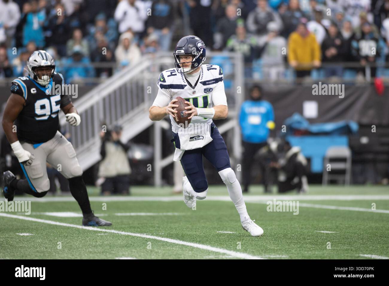Seattle Seahawks quarterback Sam Darnold (14) rolls out of the pocket ...