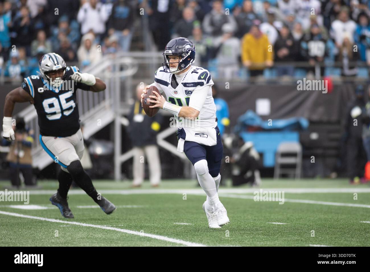 Seattle Seahawks quarterback Sam Darnold (14) rolls out of the pocket ...