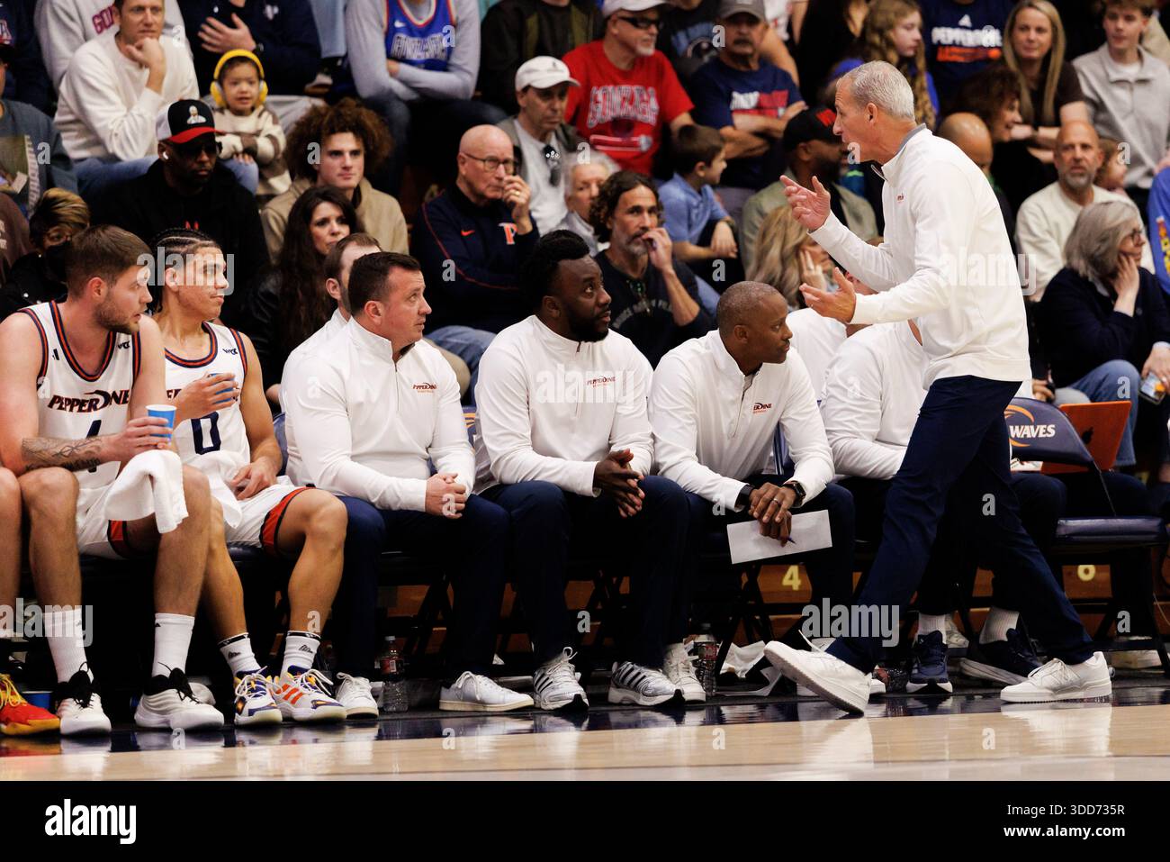 Pepperdine head coach Ed Schilling, right, speaks with his team during ...