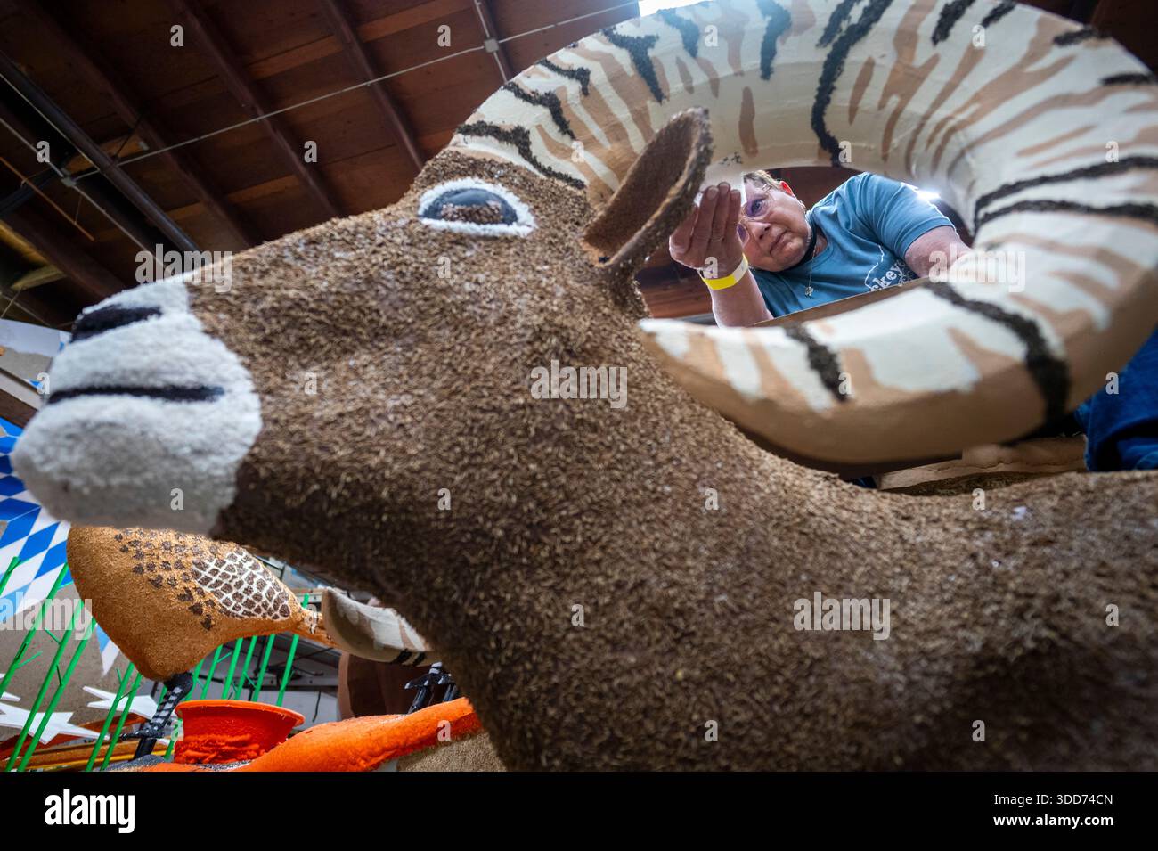 A volunteer works on a float for the 137th Rose Parade in Pasadena ...