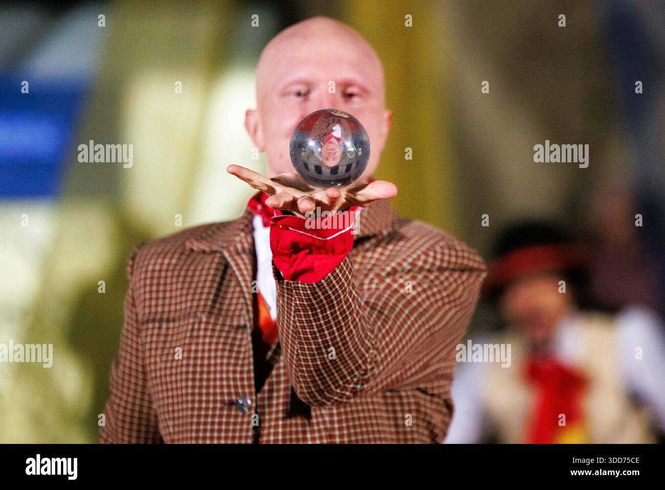 A street performer juggles a crystal ball during the Ana Mraz 2025 ...