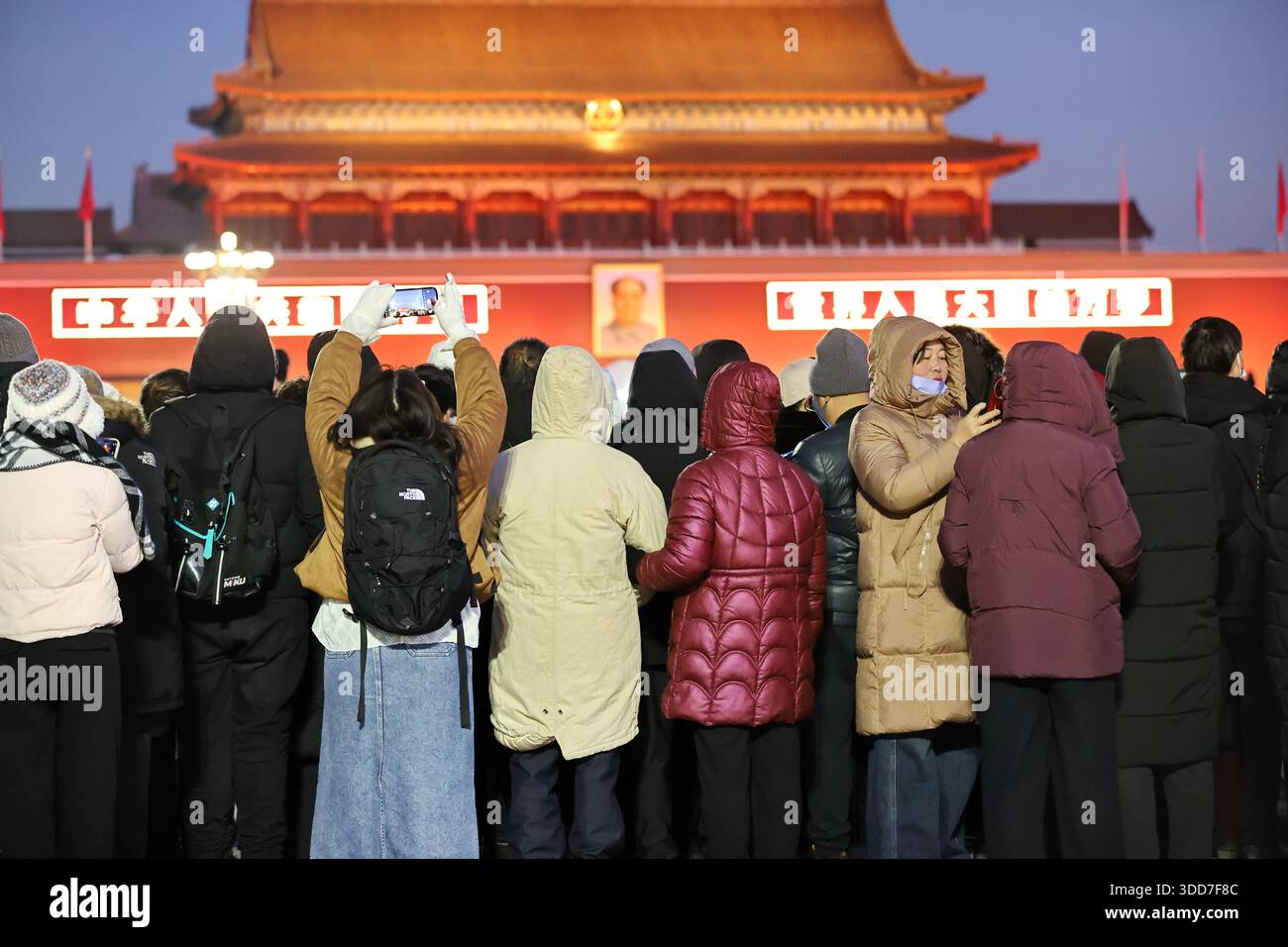 People attend the flag-raising ceremony at Tiananmen Square in Beijing ...