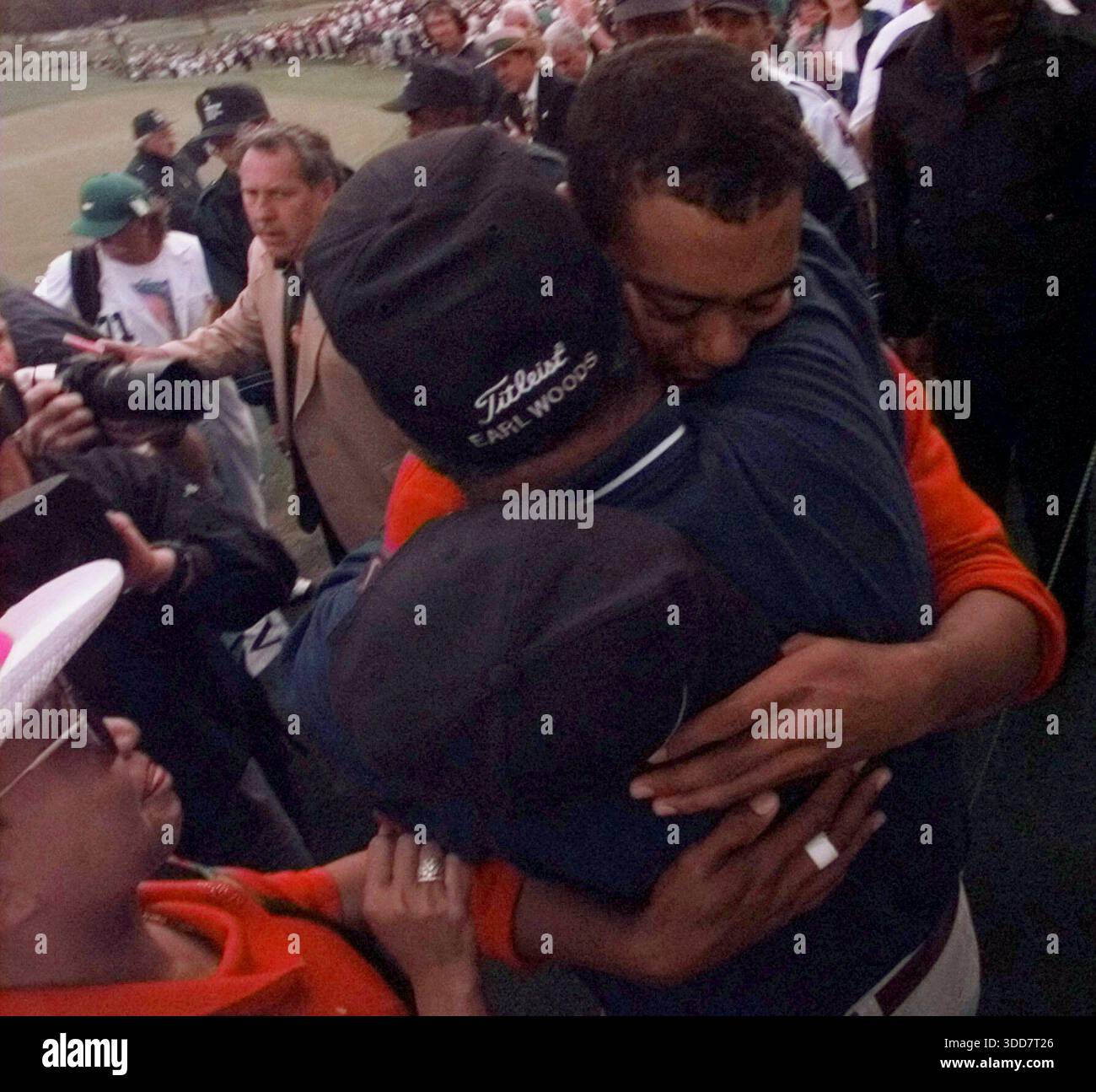 FILE - Tiger Woods hugs his his father Earl, as his mother, Kultida ...