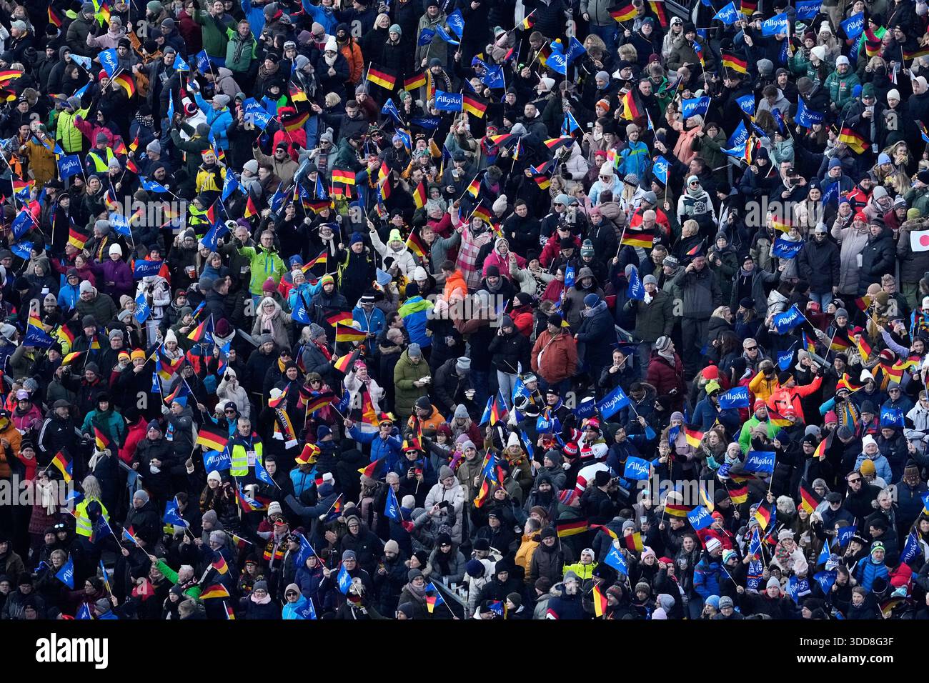 Fans wave German flags while watching the athletes' trial jumps at the ...