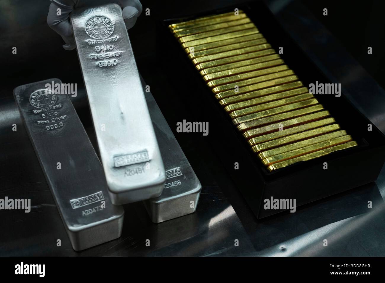 FILE - An employee of Pro Aurum gold house lifts 1 Kg silver bars of ...