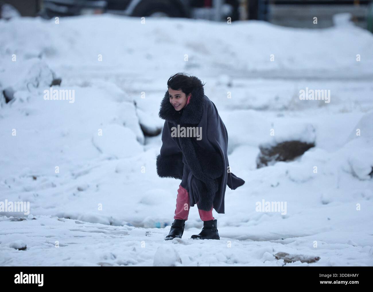 Residents of Baharka district celebrate the first significant snowfall ...
