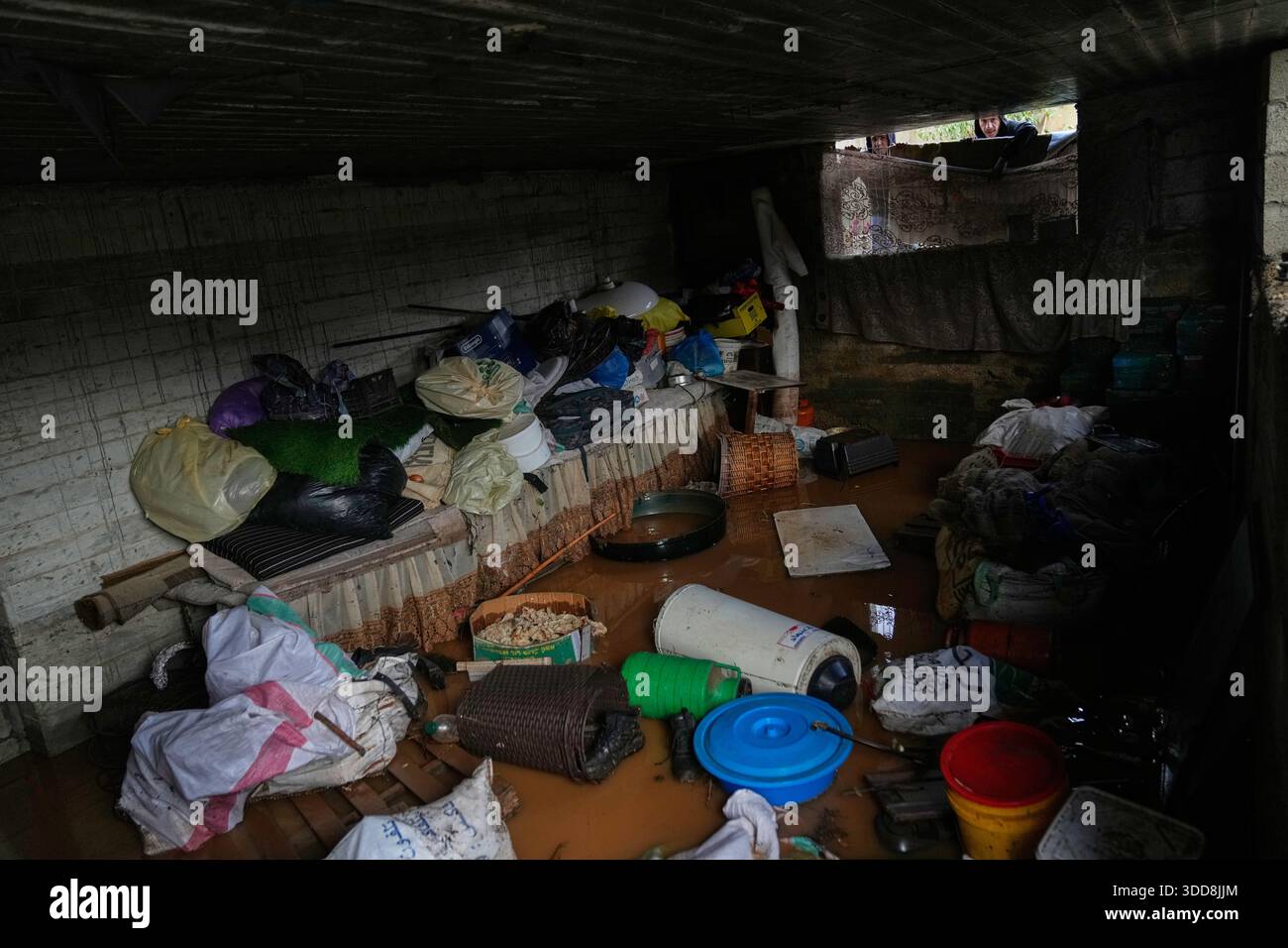 Palestinian residents inspect their rain flooded house, during a ...
