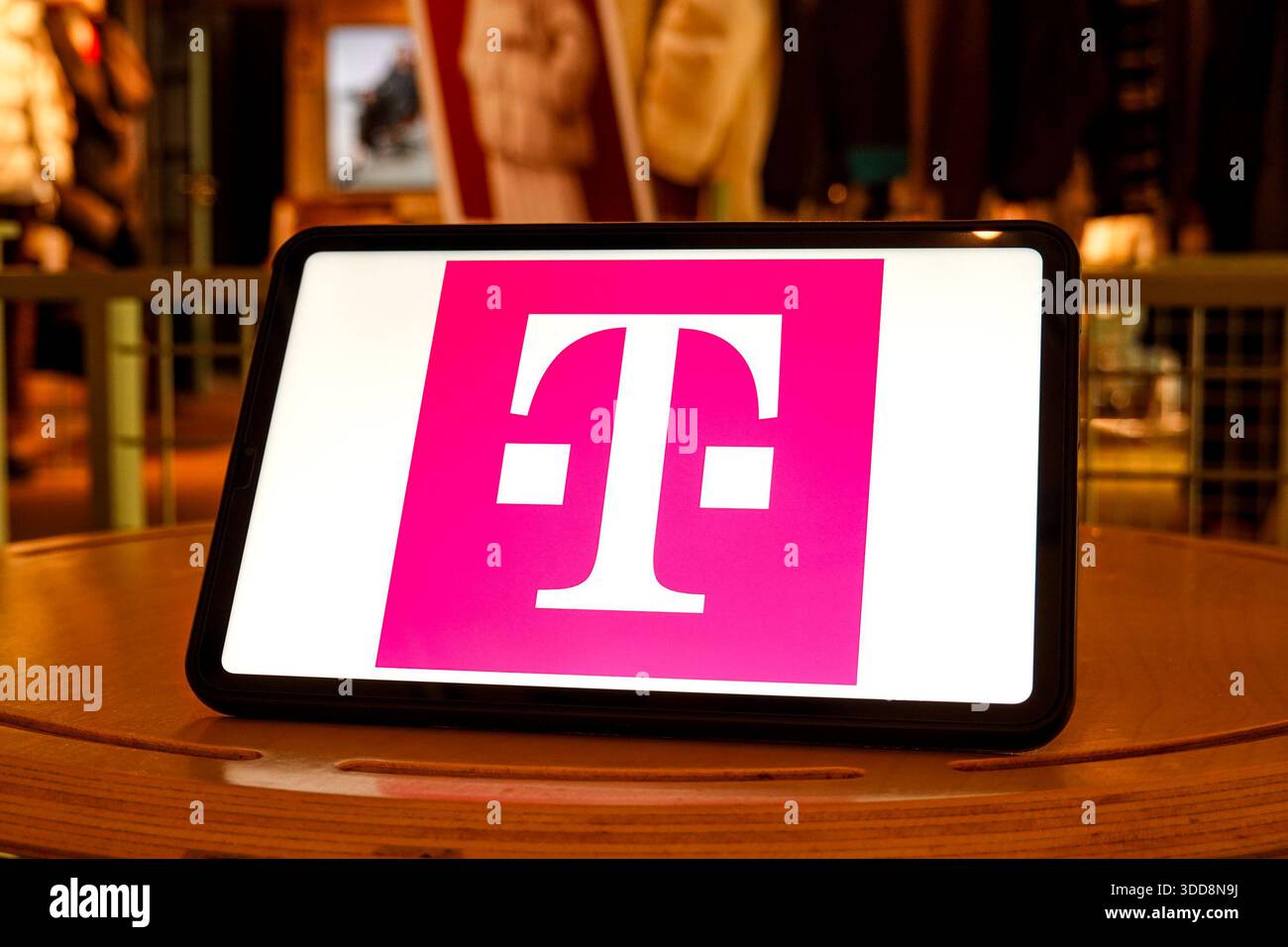 In this photo illustration, the logo of T-Mobile is seen displayed on ...