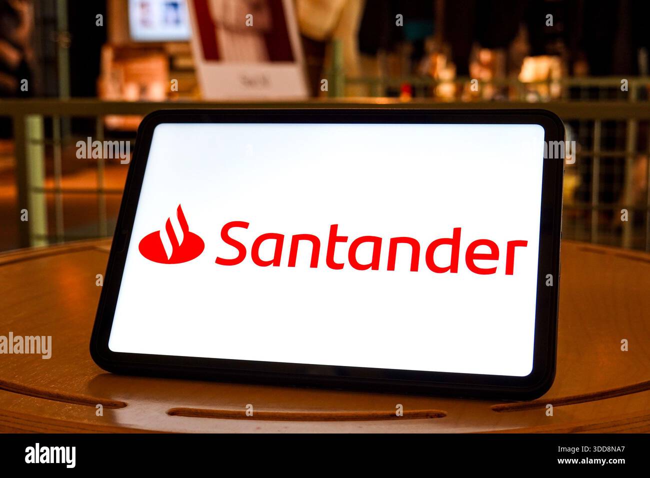 In this photo illustration, the logo of Santander is seen displayed on ...