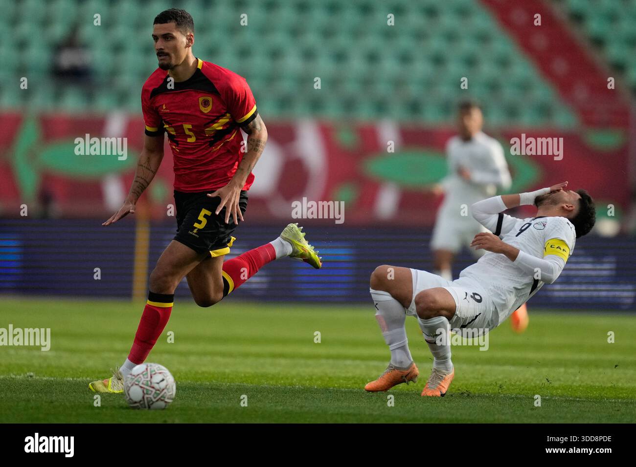 Angola's David Carmo runs with ball past the Egypt's Salah Mohsen ...