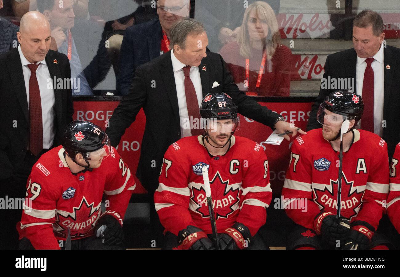 Canadian head coach Jon Cooper (back centre) behind the bench with ...
