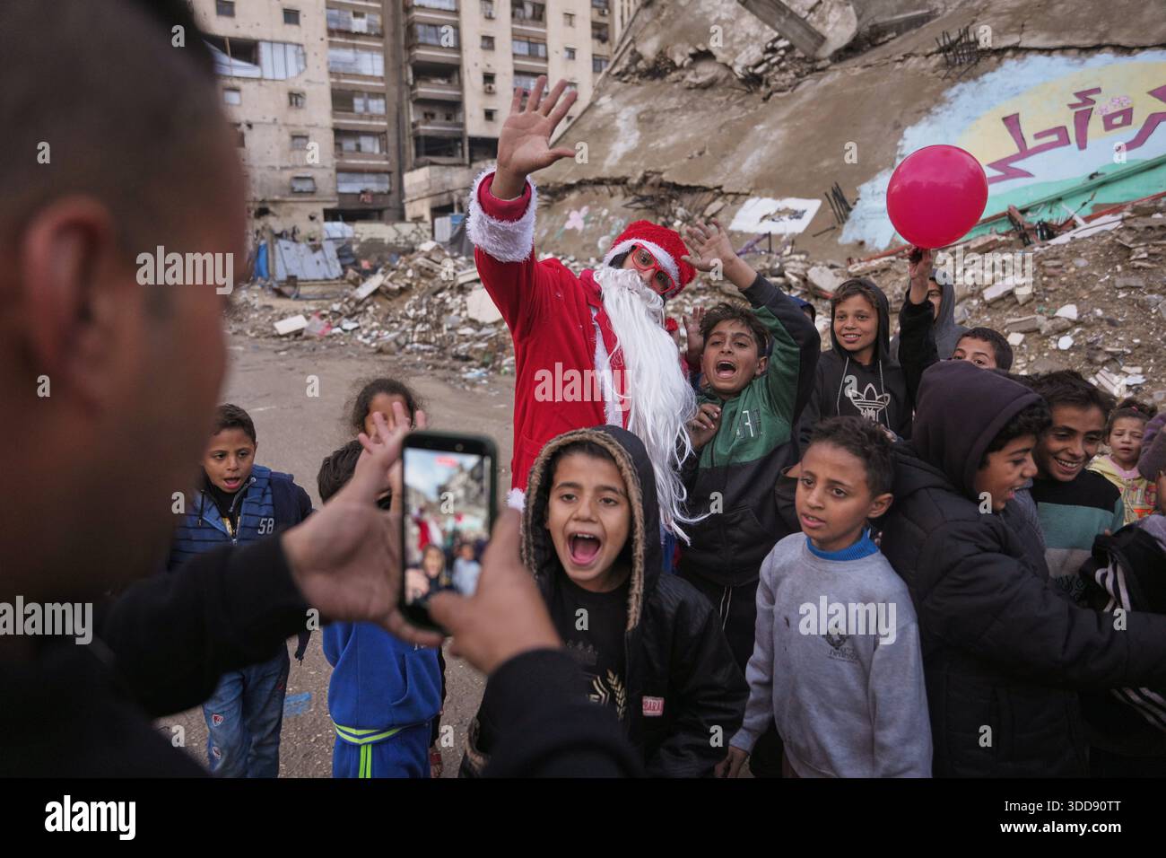Wearing a Santa Claus costume, Palestinian clown Murad Murad, 38, poses ...