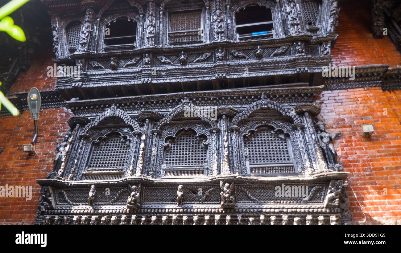 Ornate wood carvings and window on a traditional Nepali building at the ...