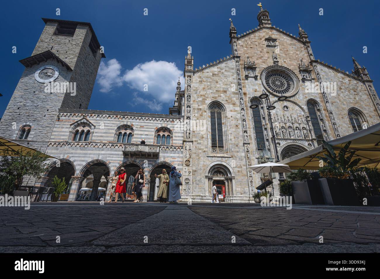 COMO, ITALY, 06.20.2025:A grand Gothic cathedral with a tall clock ...