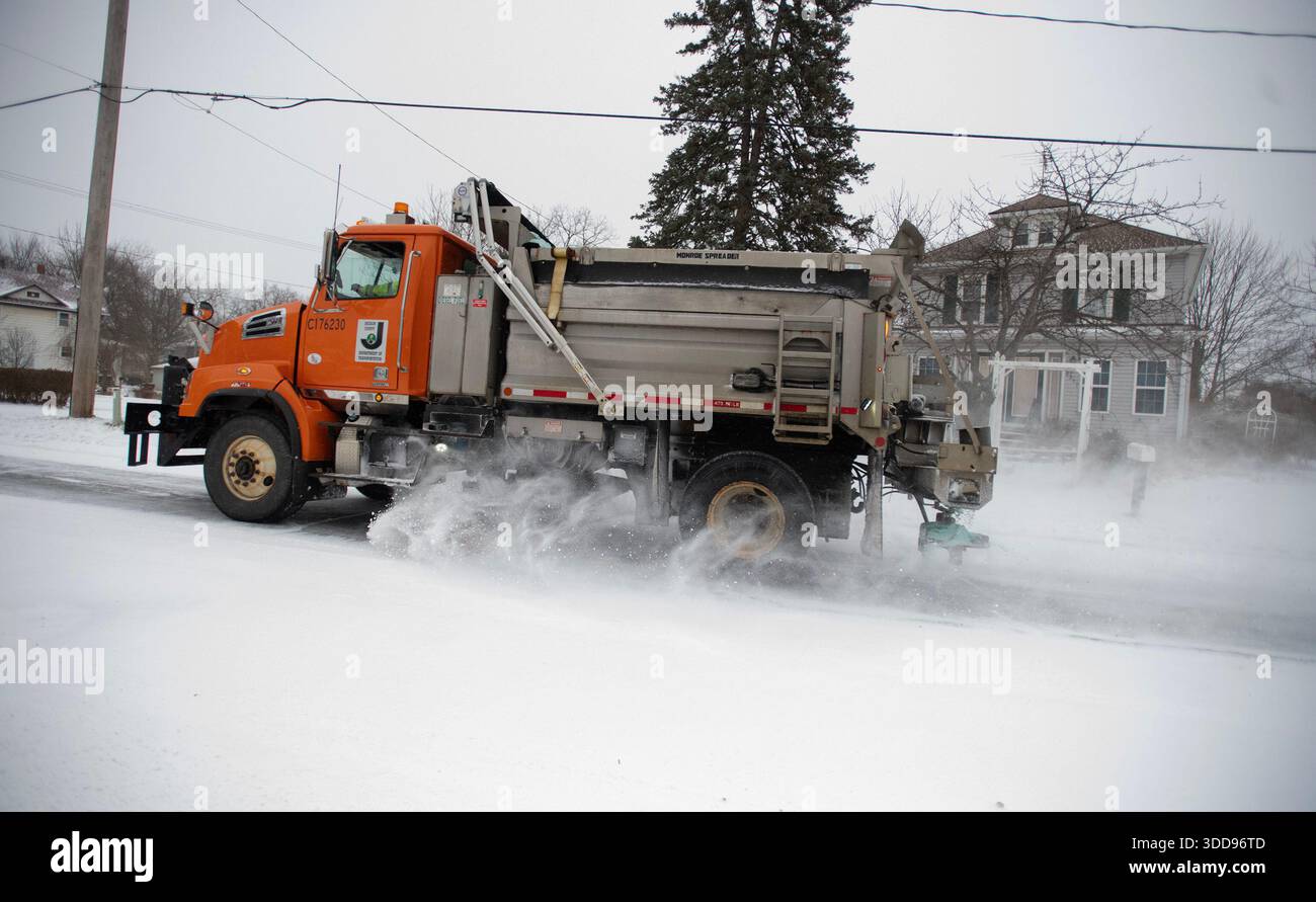 A Jackson County snowplow treats the road along Francis Street in ...