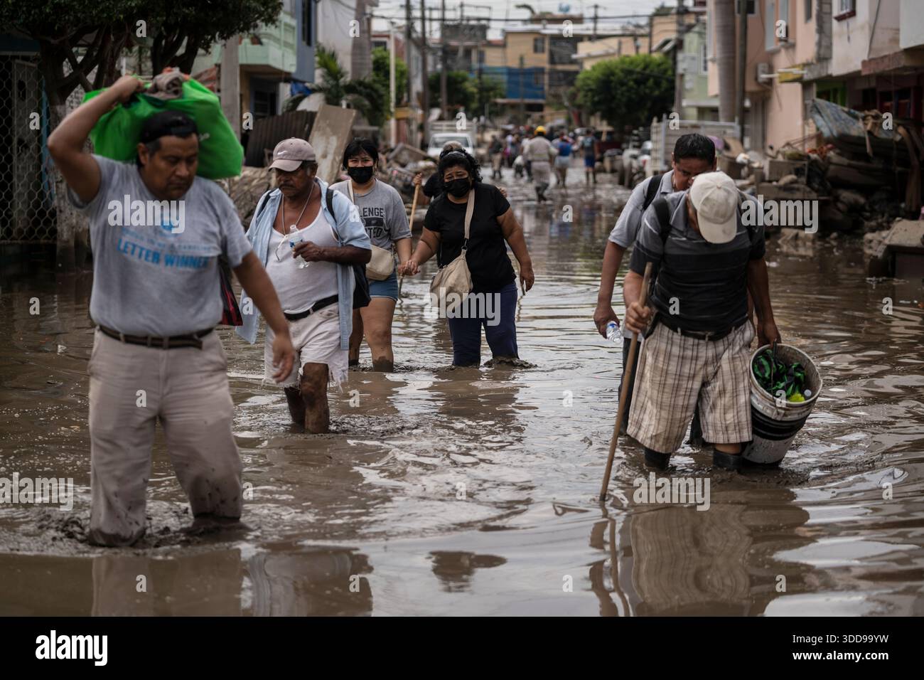 FILE - People traverse a flooded street in Poza Rica, Veracruz state ...