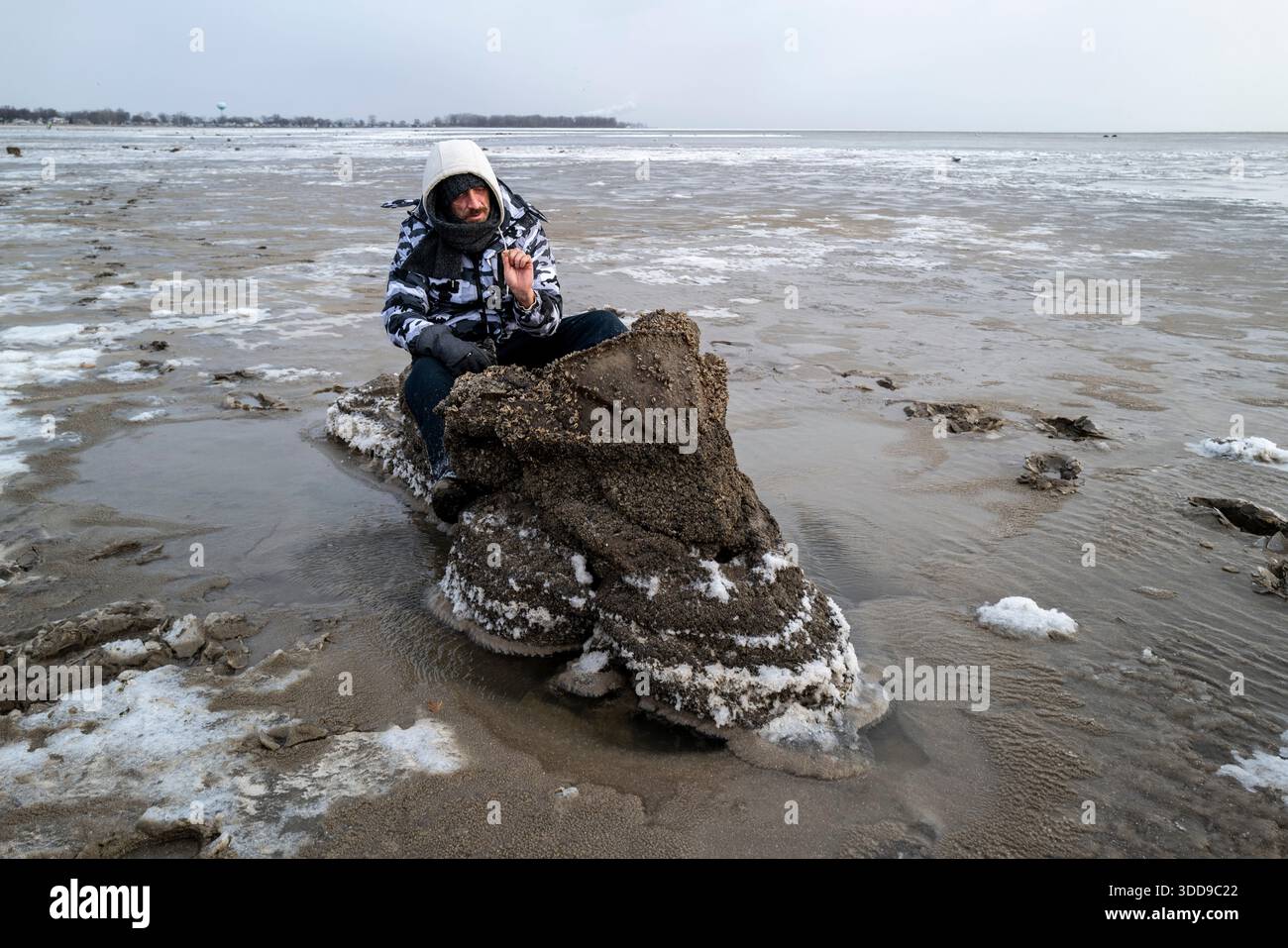 Spencer Boose, Luna Pier, sits on a mussel-covered snowmobile he and ...