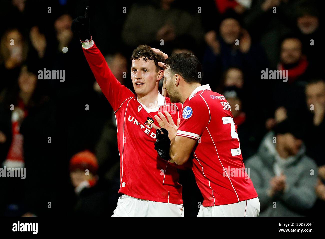 Wrexham's Nathan Broadhead (left) celebrates with team-mates after ...