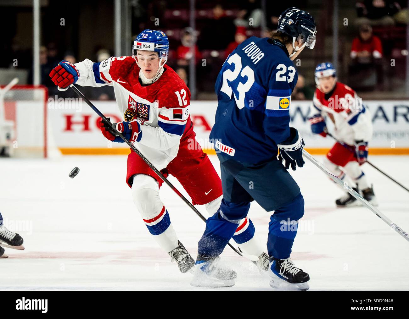 Czechia's Max Curran (12) skies around Finland's Leo Tuuva (23) during ...