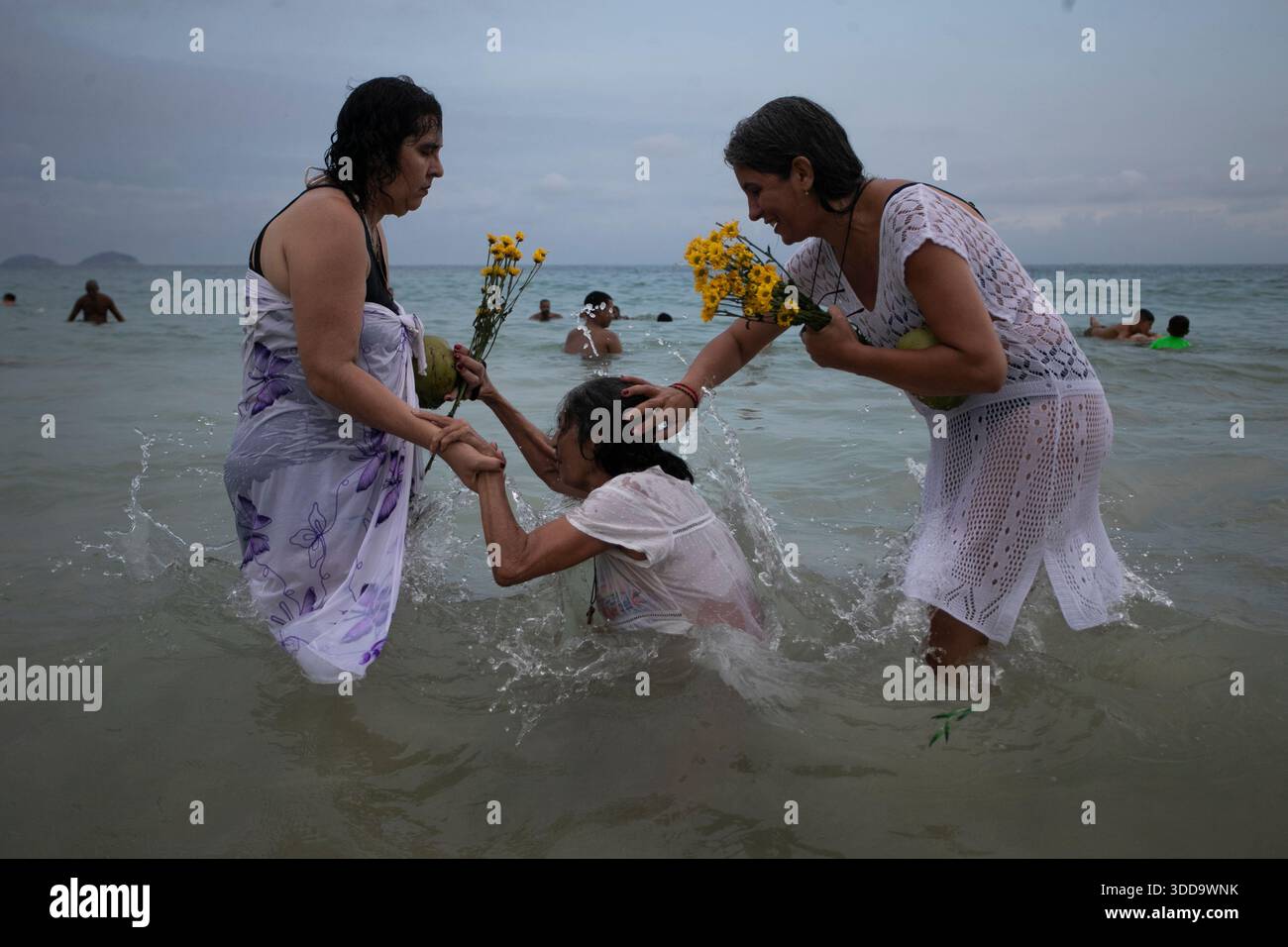 People pray on Copacabana Beach during a ceremony honoring Yemanja, the ...