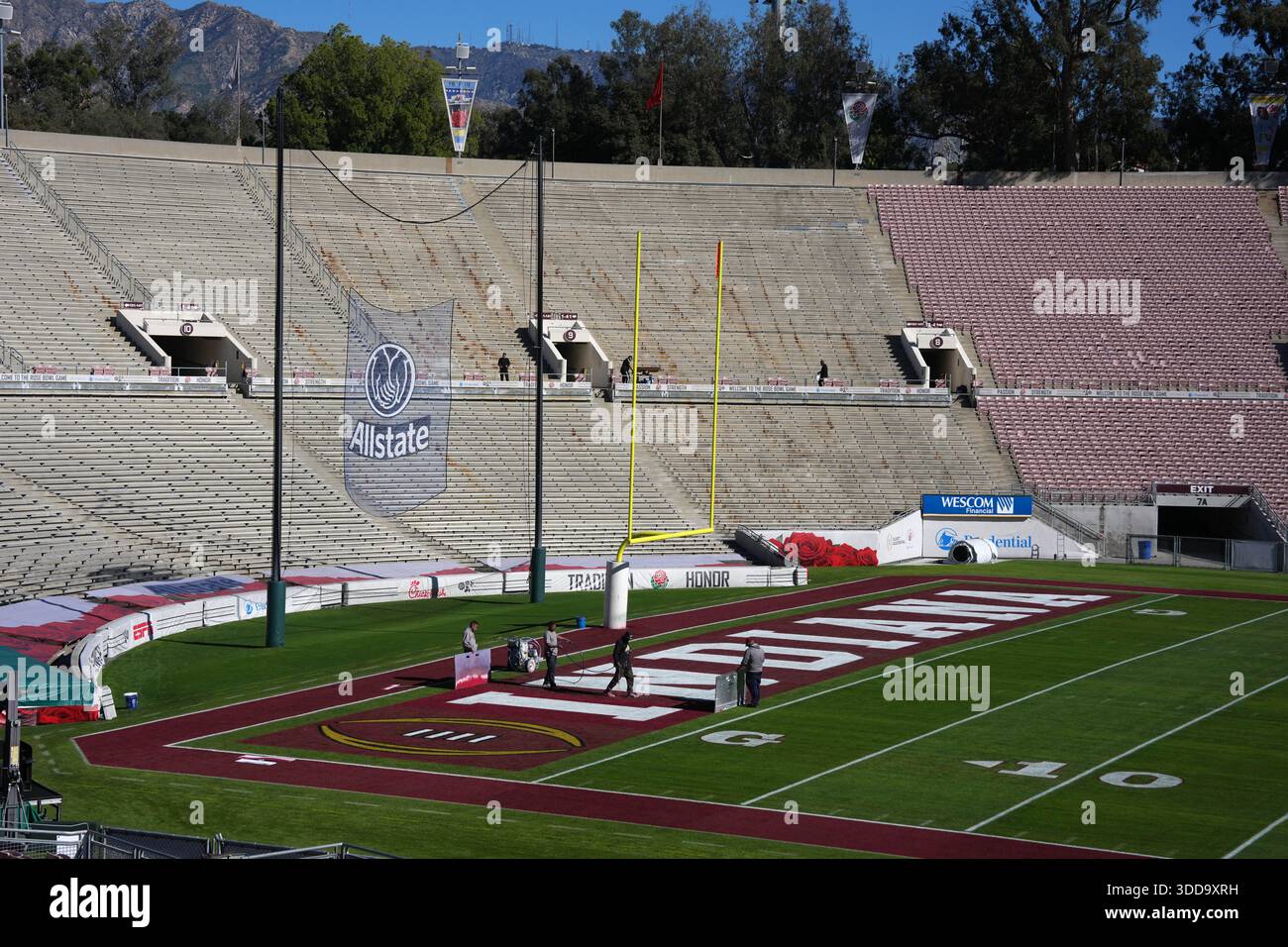 Workers paint the Indiana Hoosiers logo in the Rose Bowl Stadium end ...