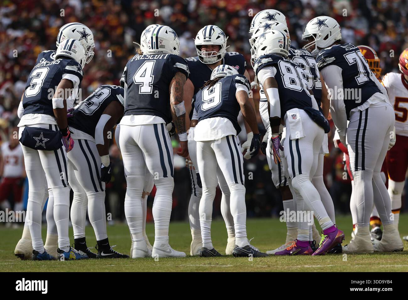 Dallas Cowboys players huddle up during an NFL football game against ...
