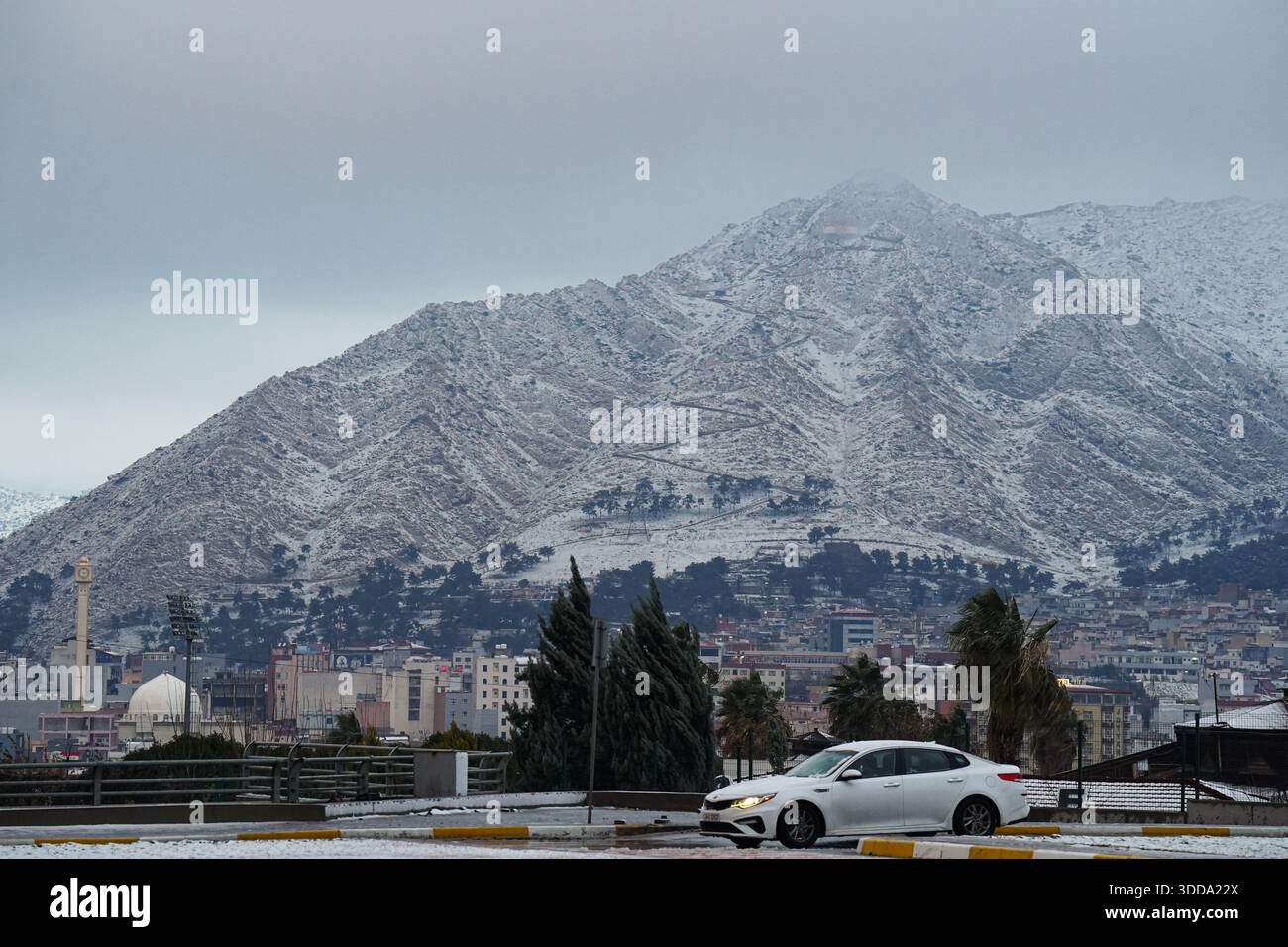 A general view shows snow covering the mountains surrounding the city ...