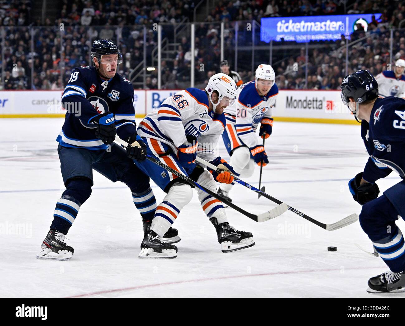 Edmonton Oilers' Max Jones (46) is checked by Winnipeg Jets' Jonathan ...