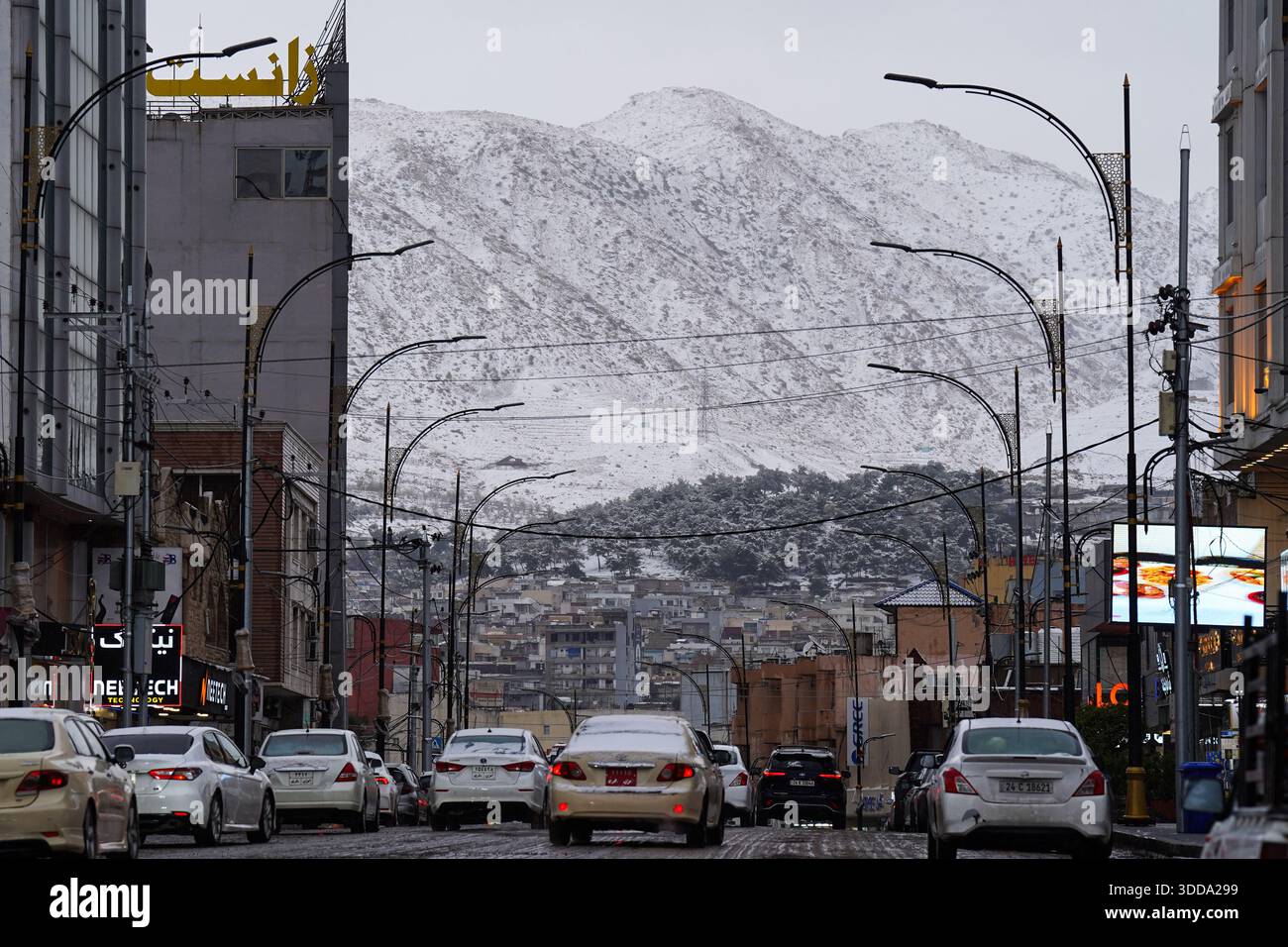 A general view shows snow covering the mountains surrounding the city ...