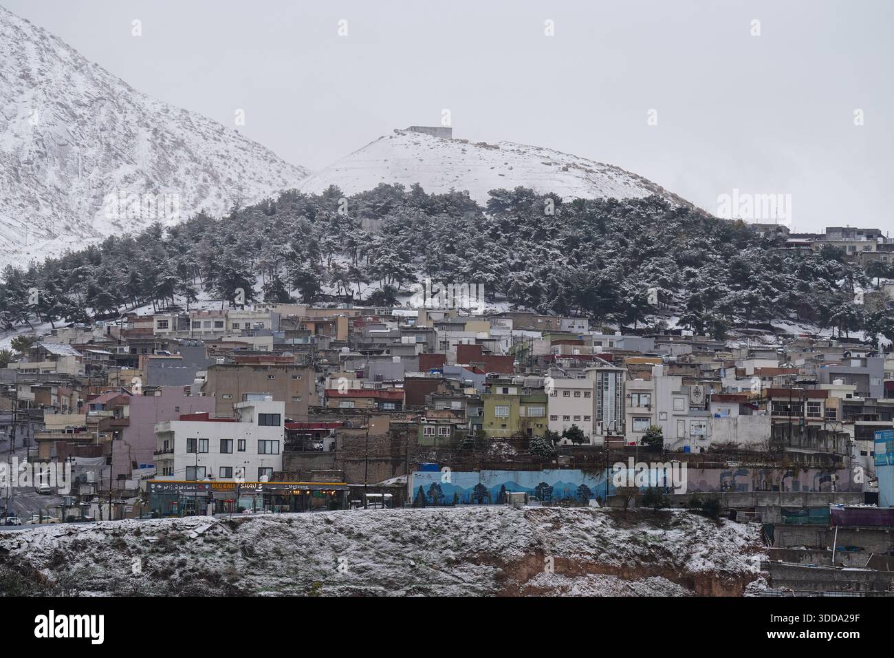 A general view shows snow covering the mountains surrounding the city ...