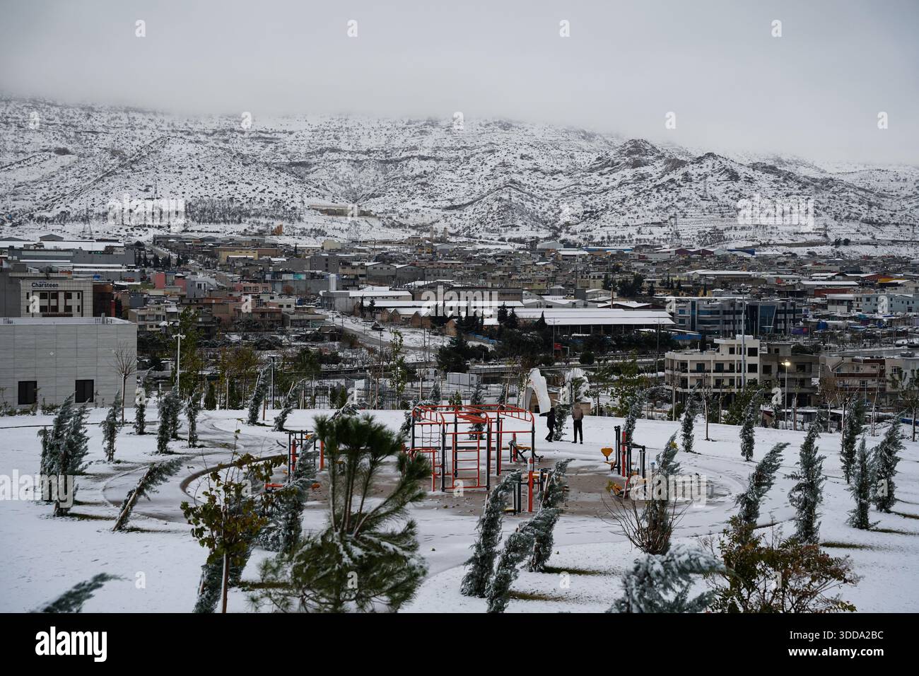 A general view shows snow covering the mountains surrounding the city ...