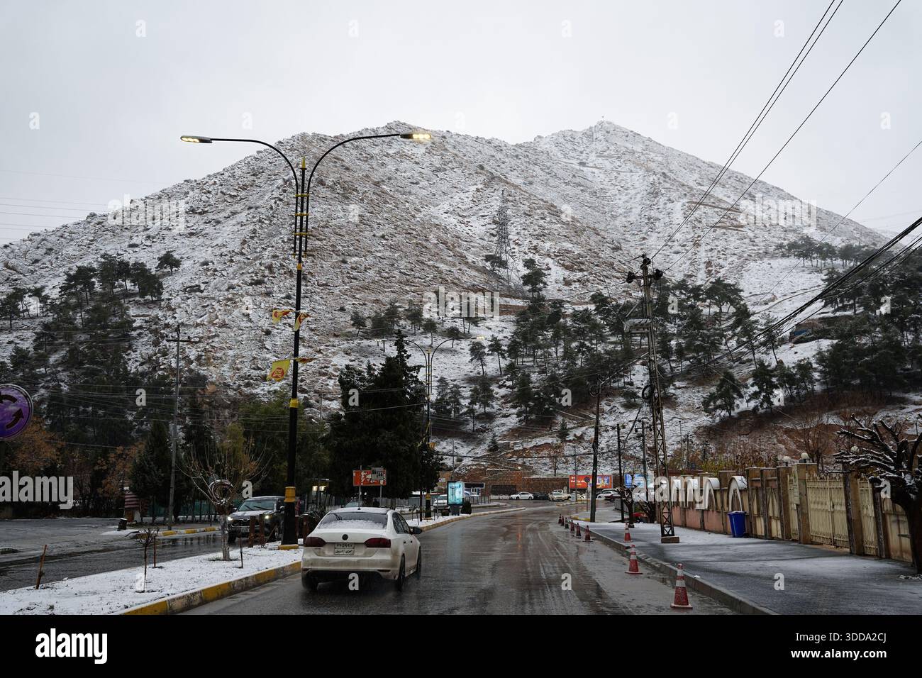 A general view shows snow covering the mountains surrounding the city ...