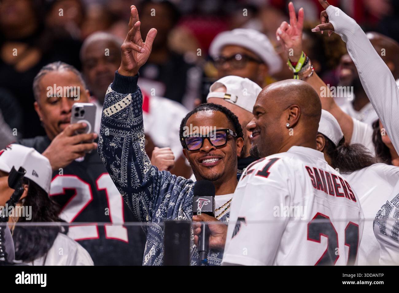 Rapper T.I. waves during the second half of an NFL football game ...