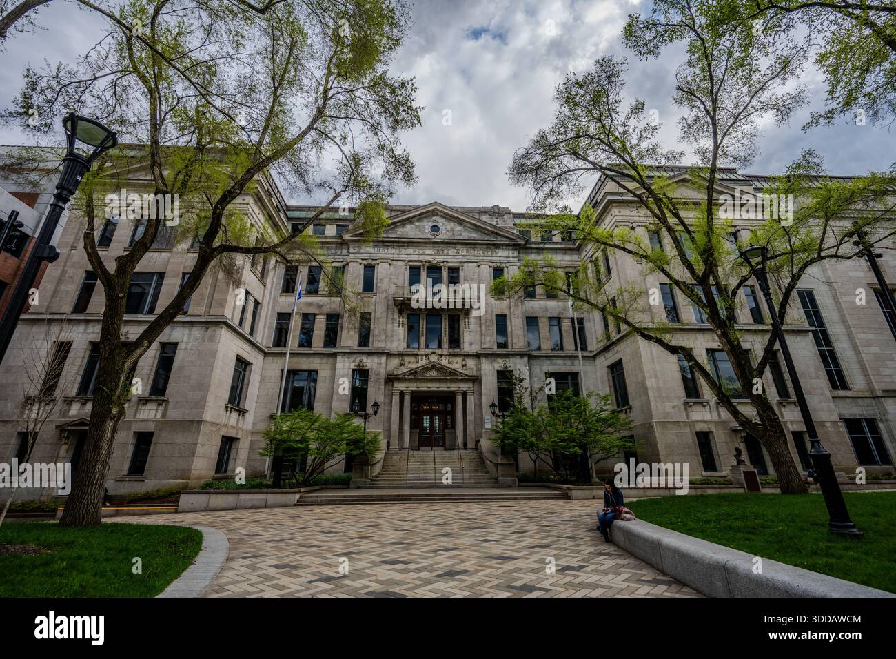 A grand stone university building with columns and multiple windows is ...