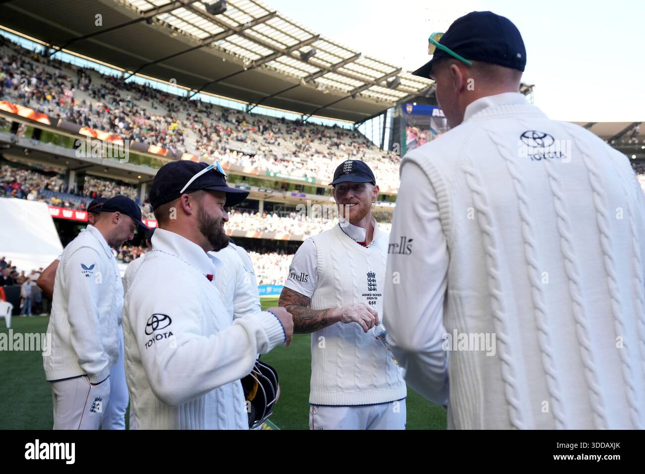England's Ben Stokes (centre) talks with Ben Duckett (left) on day one ...