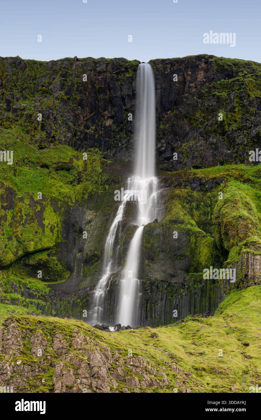 A vertical view of the beautiful Bjarnafoss Waterfall on the ...