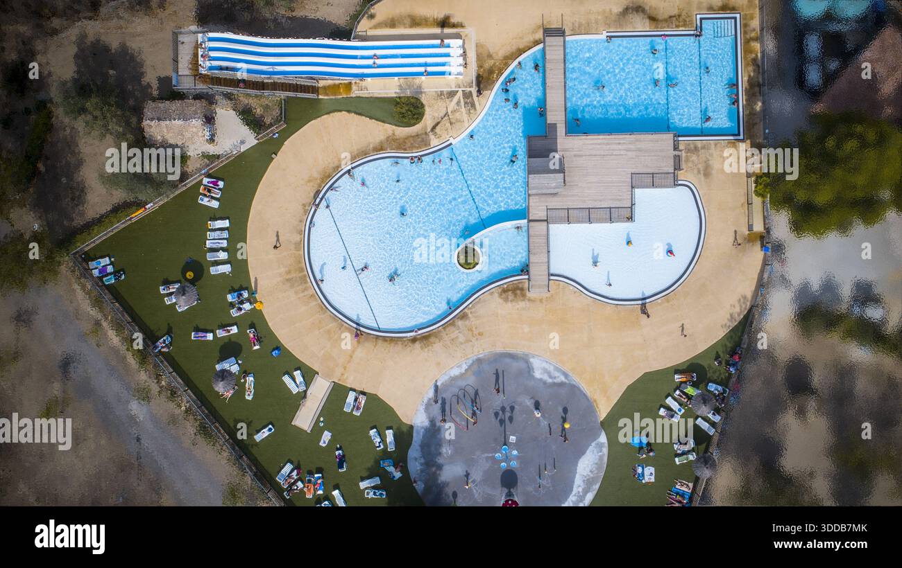 Aerial view of shimmering pools reflecting the azure sky, framed by sun ...