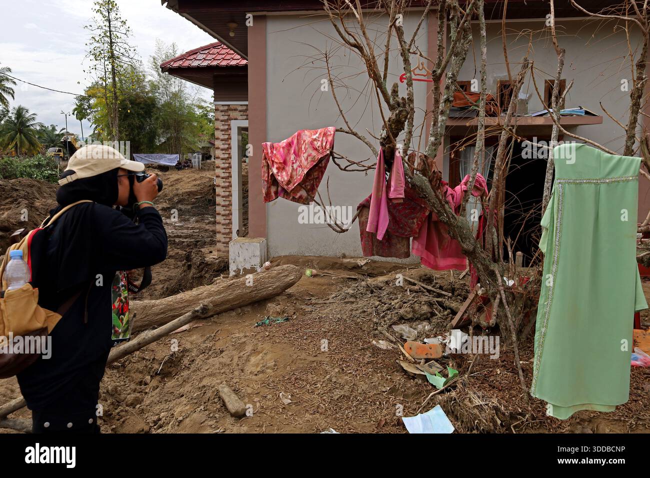 December 30, 2025, Pidie Jaya, Aceh, Indonesia: A female photographer ...