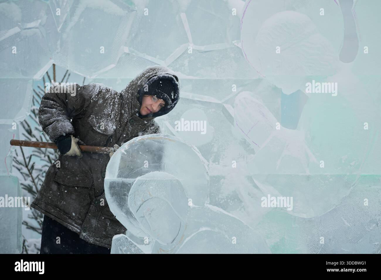An artist carves an ice sculpture of a nativity scene for the Icy ...