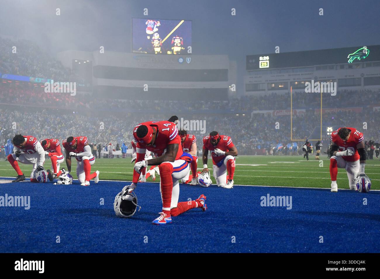 Buffalo Bills players take a knee in the endzone before an NFL football ...