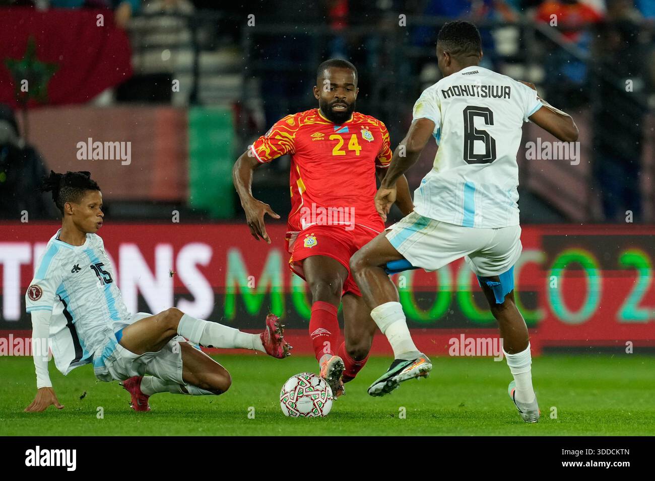 DR Congo's Gedeon Kalulu, center, challenges for the ball with Botswana ...
