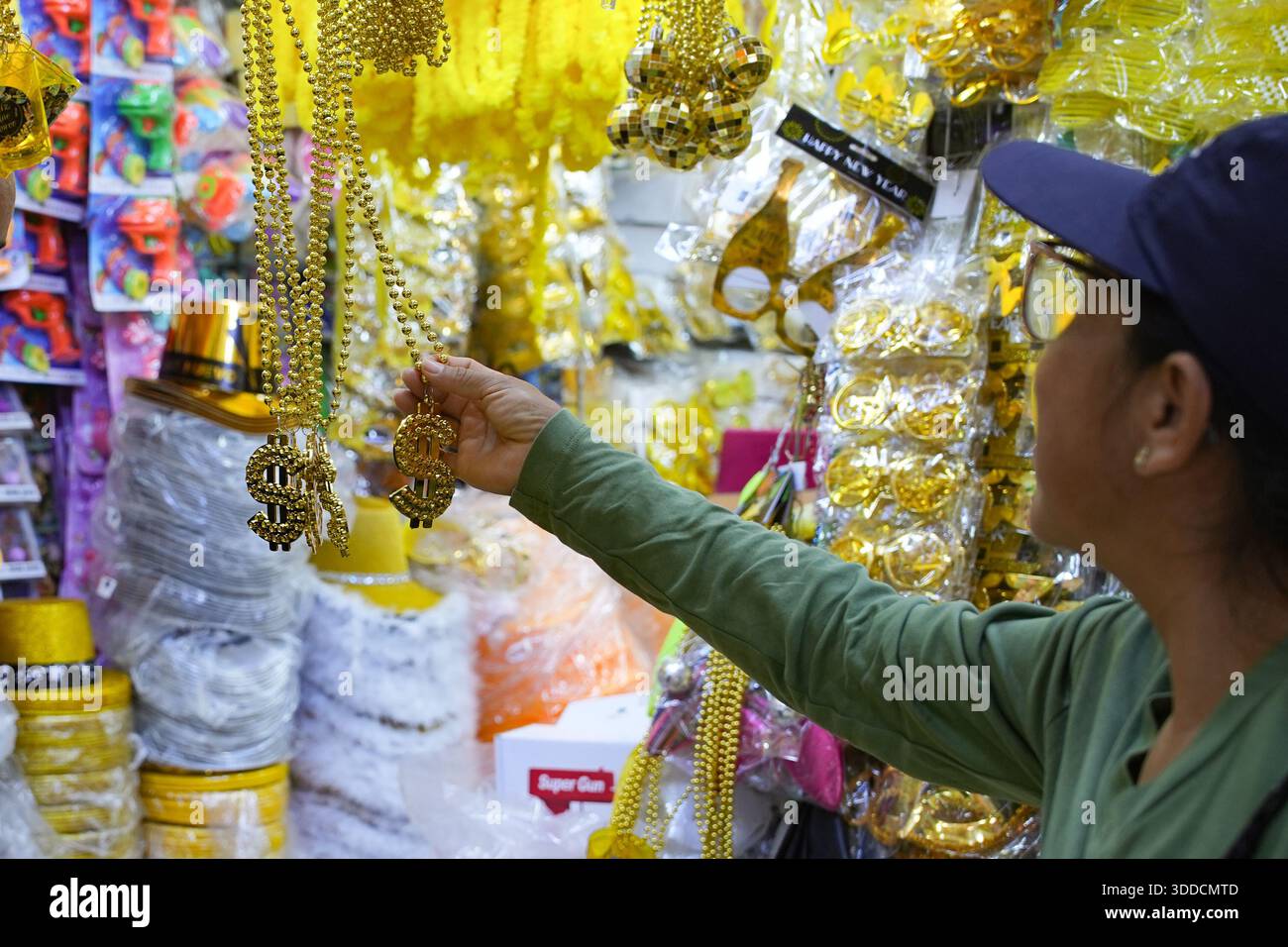 A woman looks for New Year's eve party goods at a market in downtown ...