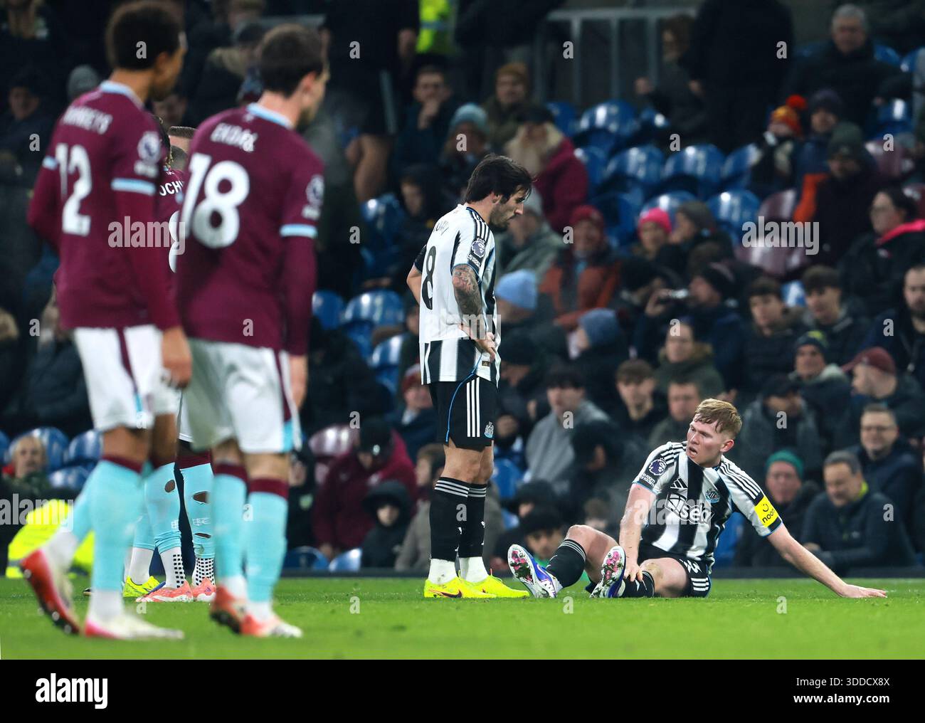 Newcastle United's Lewis Hall reacts to an injury during the Premier ...