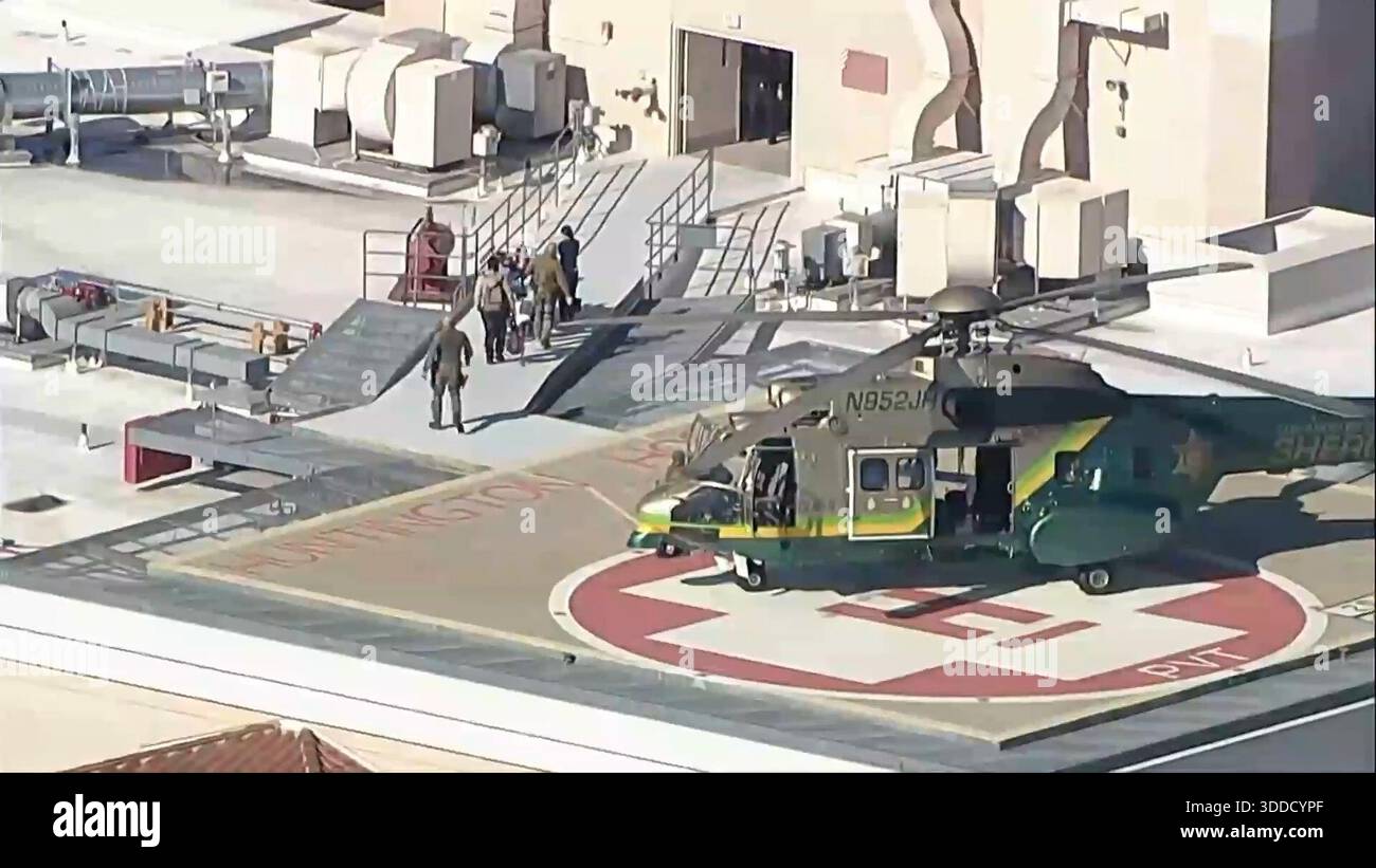 Individuals are stretchered off after a police helicopter lands on ...