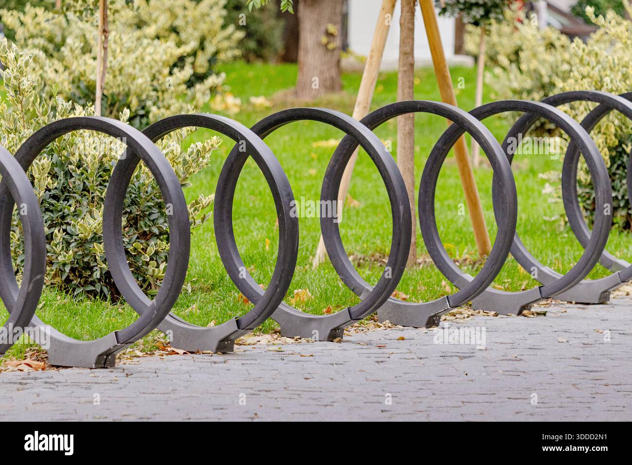 Modern bicycle rack featuring circular metal elements providing parking ...