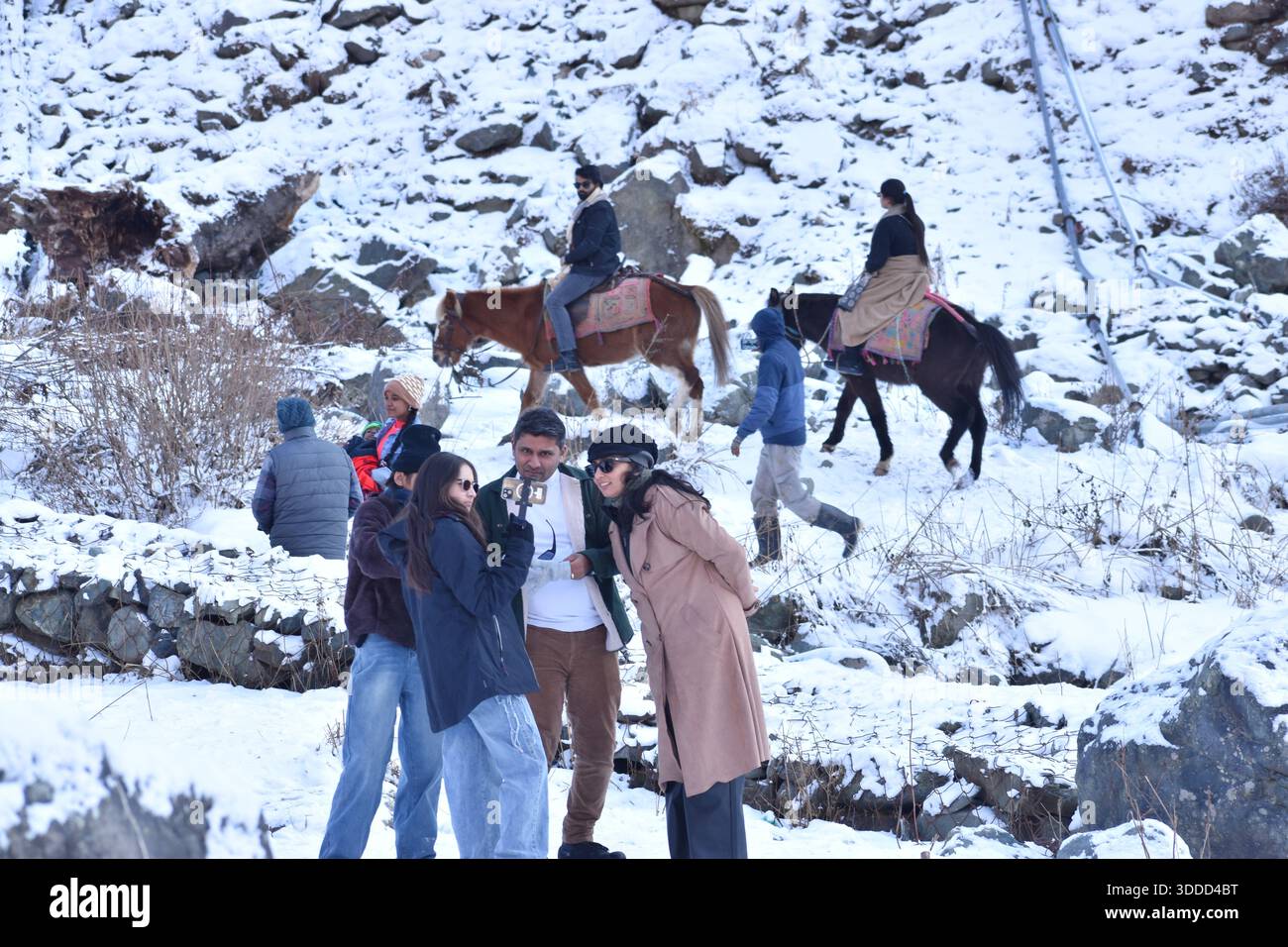 Tourists enjoy a walk at snow mountain after a heavy snowfall at ...