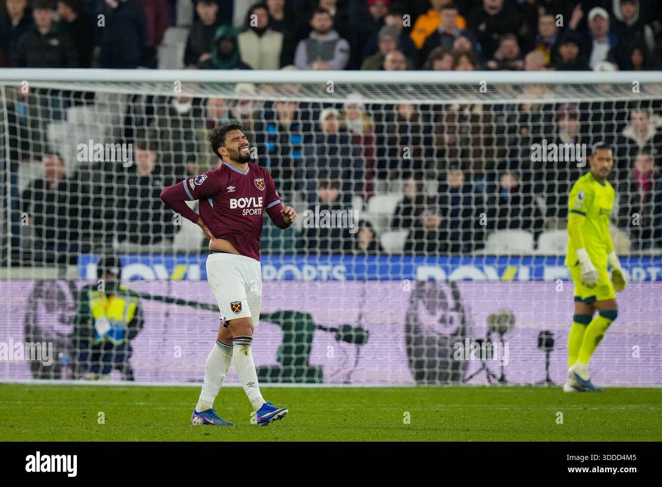 Lucas Paquetá of West Ham United clutches his lower back with a ...