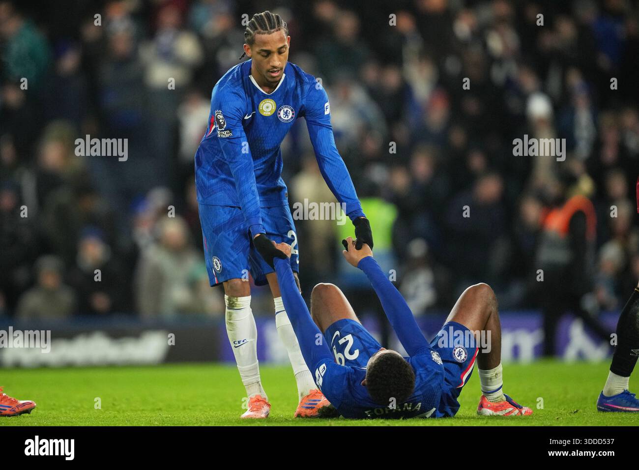 Chelsea's Joao Pedro, top, helps Wesley Fofana stand up after the ...