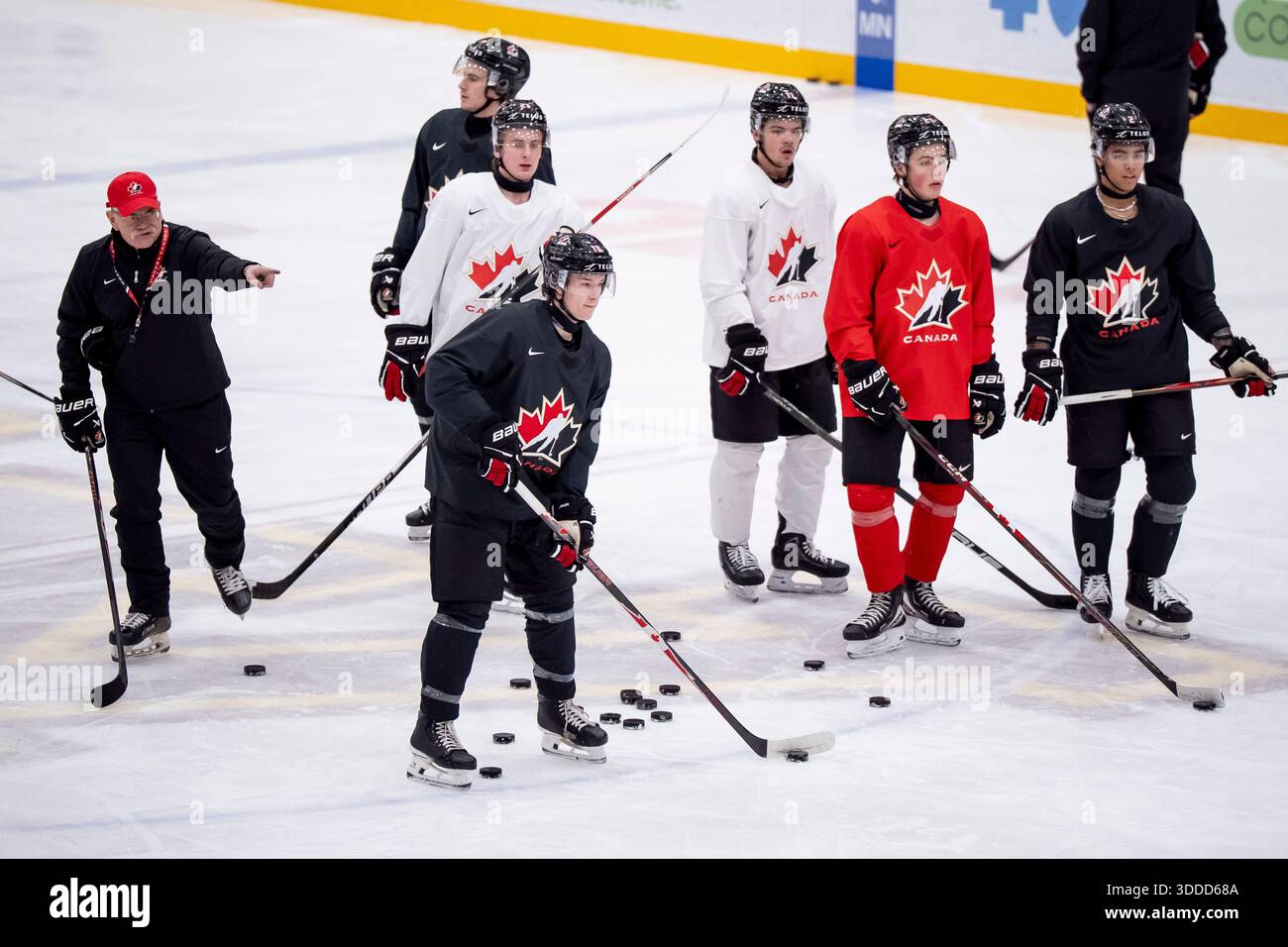 Team Canada assistant coach Gardiner MacDougall, left, gestures at a ...